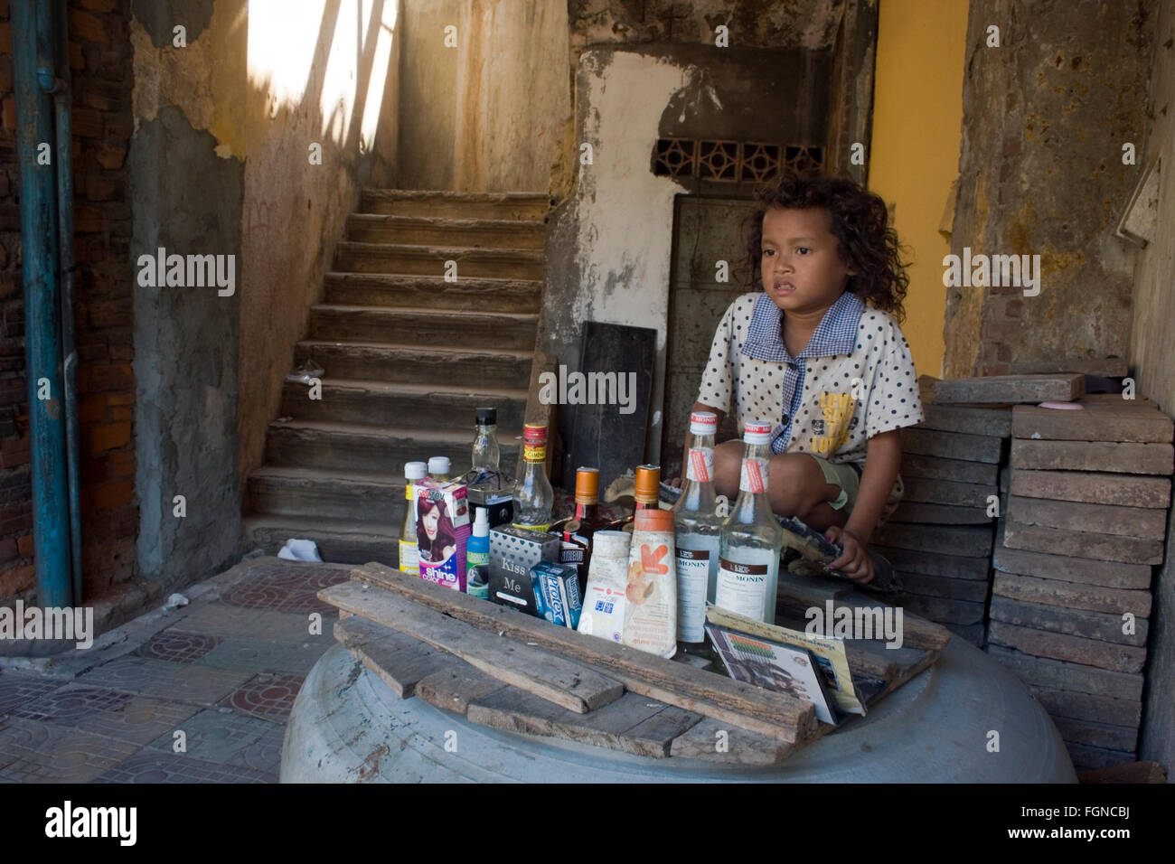 A Young Girl Living In Poverty Tends To A Make Believe Store She Assembled With Garbage At Her