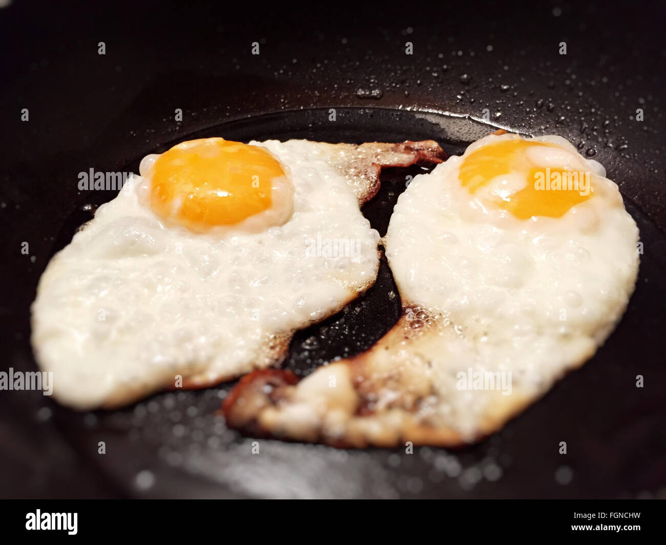 Cooking fried eggs in frying pan Stock Photo - Alamy