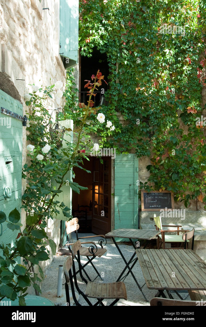 The courtyard of an old restaurant in a hilltop village of Provence ...