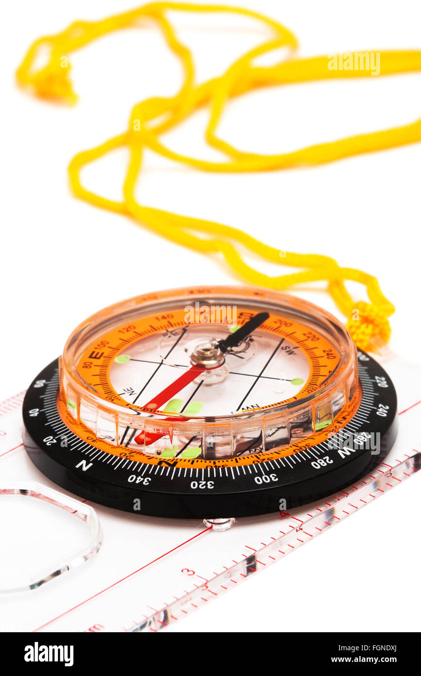 Compass with a yellow cord on a white background Stock Photo - Alamy