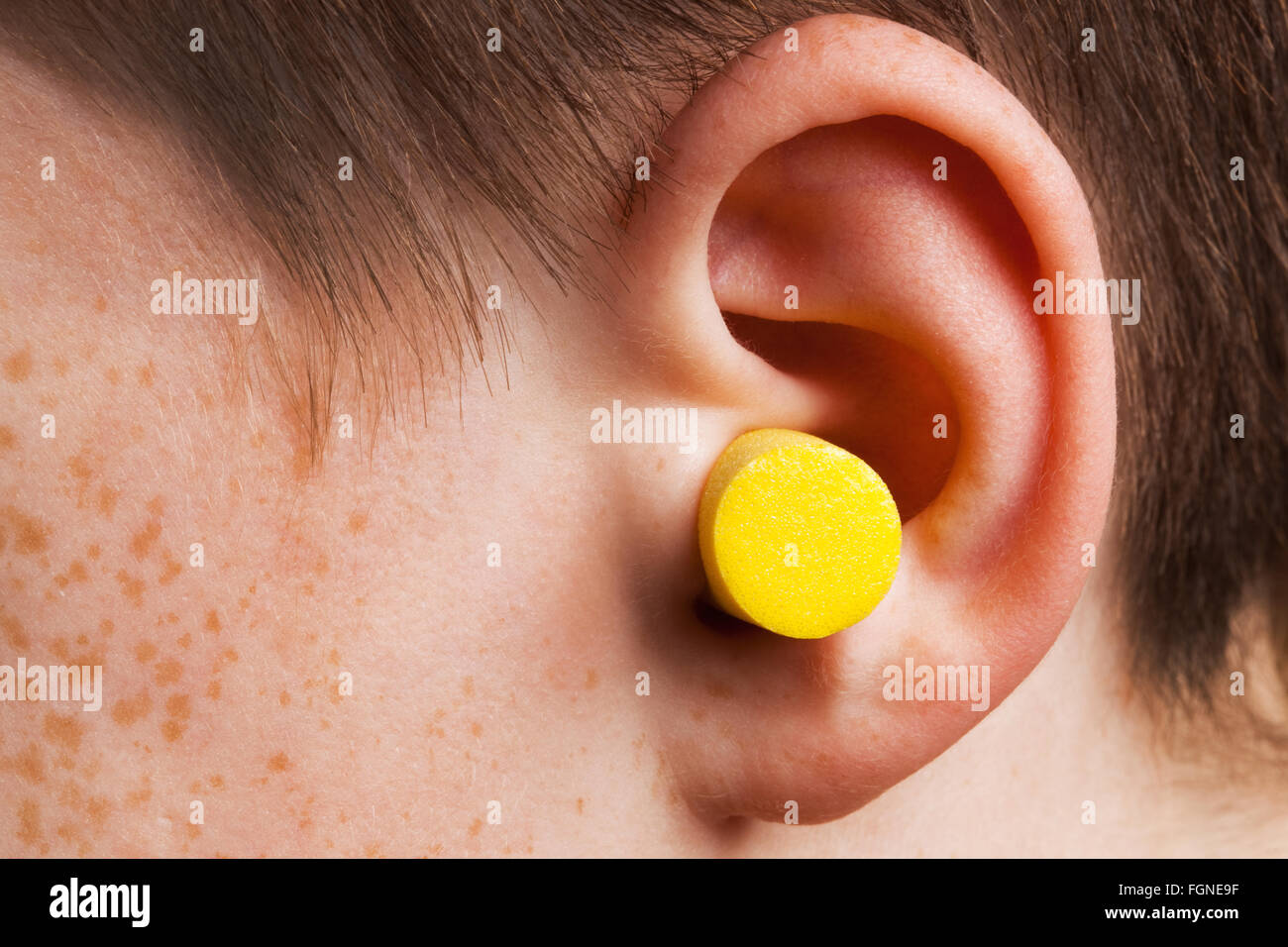 Yellow earplug ear hi-res stock photography and images - Alamy