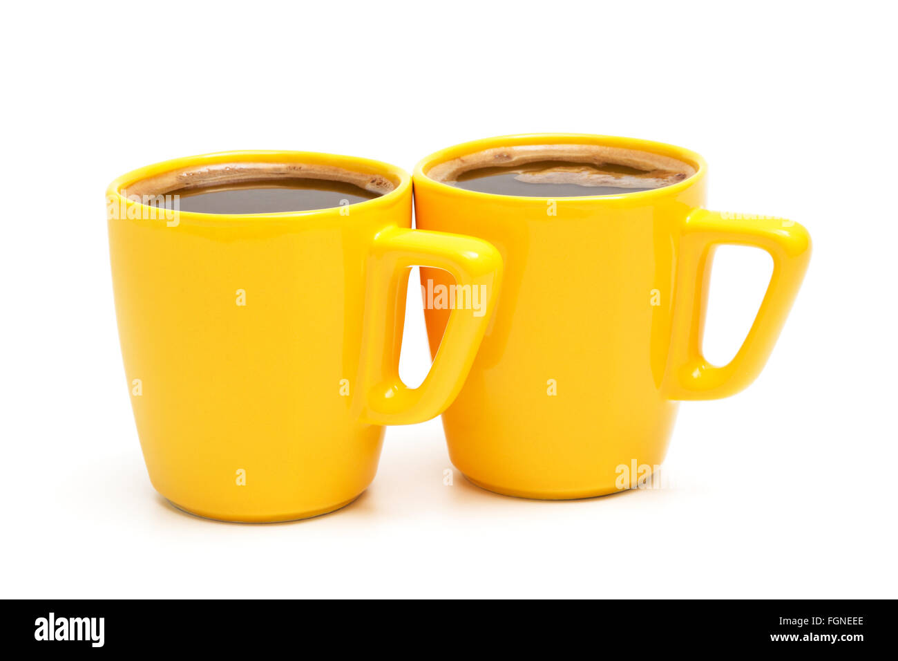 two yellow mugs of coffee on a white background Stock Photo - Alamy