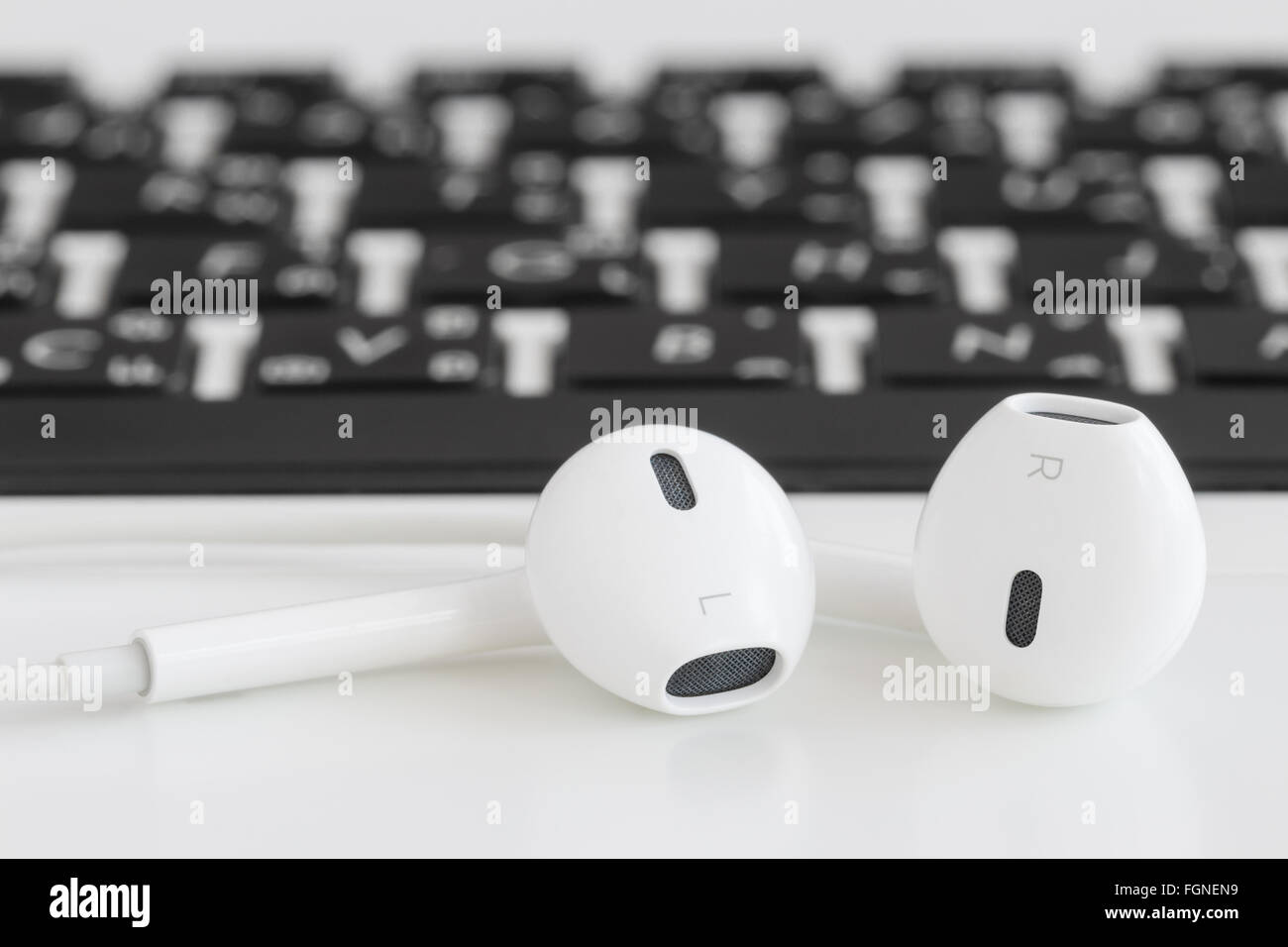 close up earbuds music accessories on laptop computer Stock Photo - Alamy