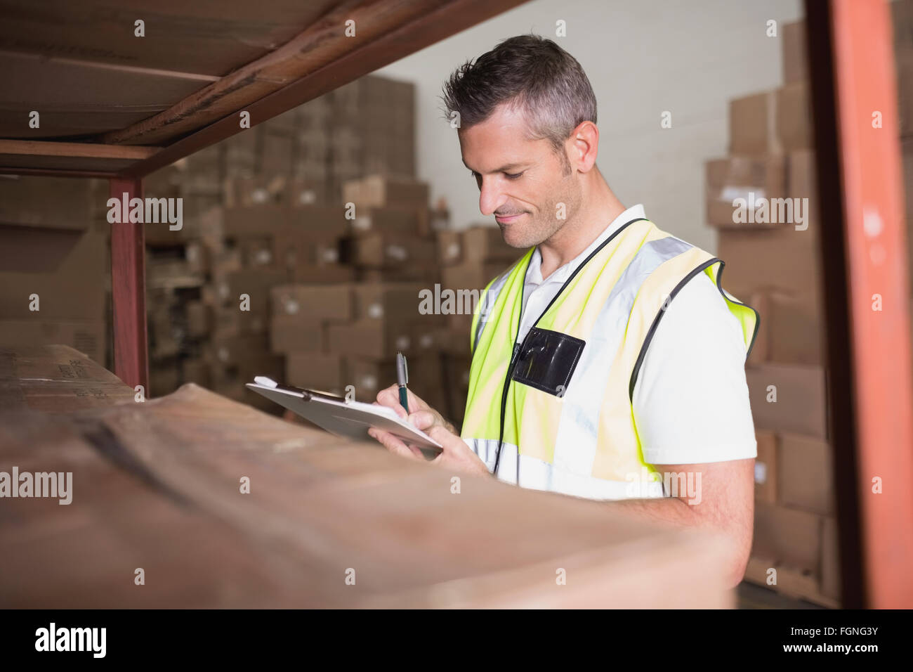 Warehouse worker with clipboard Stock Photo - Alamy