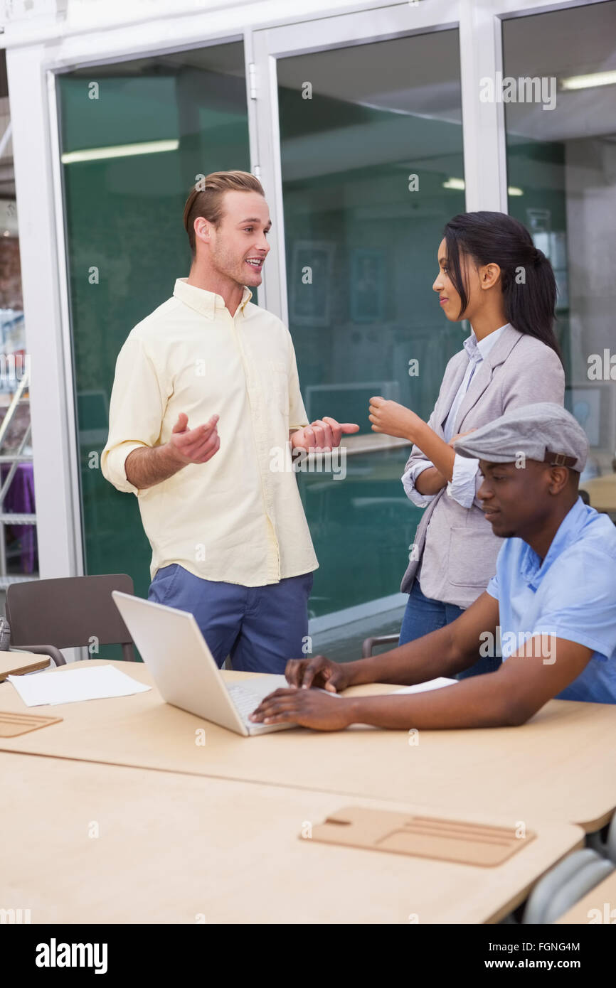 Three happy businessmen working together on a laptop Stock Photo - Alamy