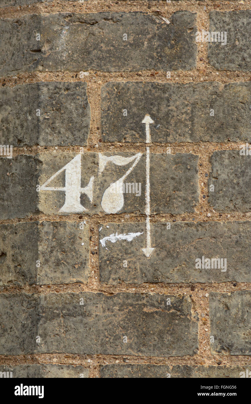 House number 47 painted sign with arrow on wall Stock Photo - Alamy
