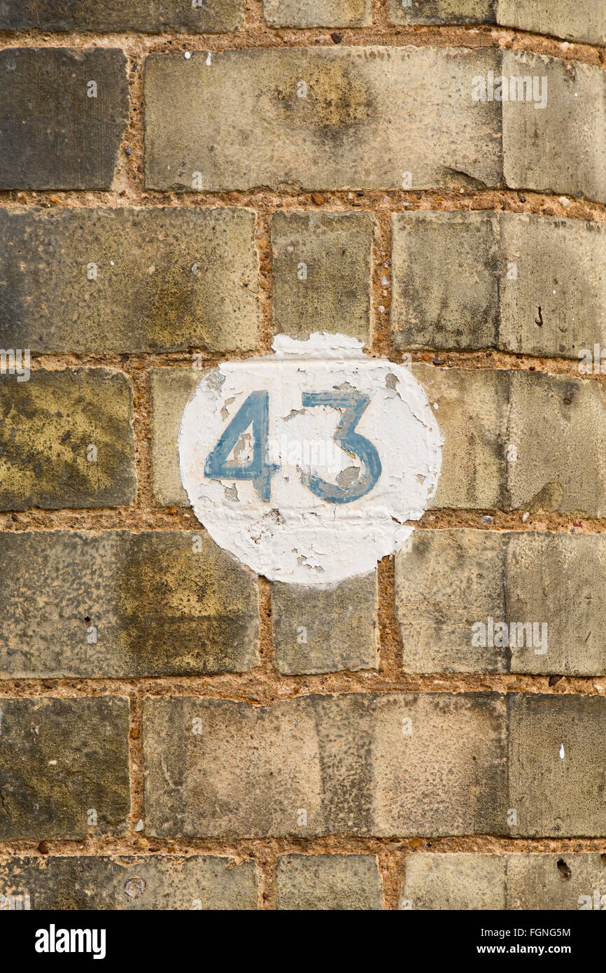 Faded hand-painted house number 43 sign on wall Stock Photo - Alamy