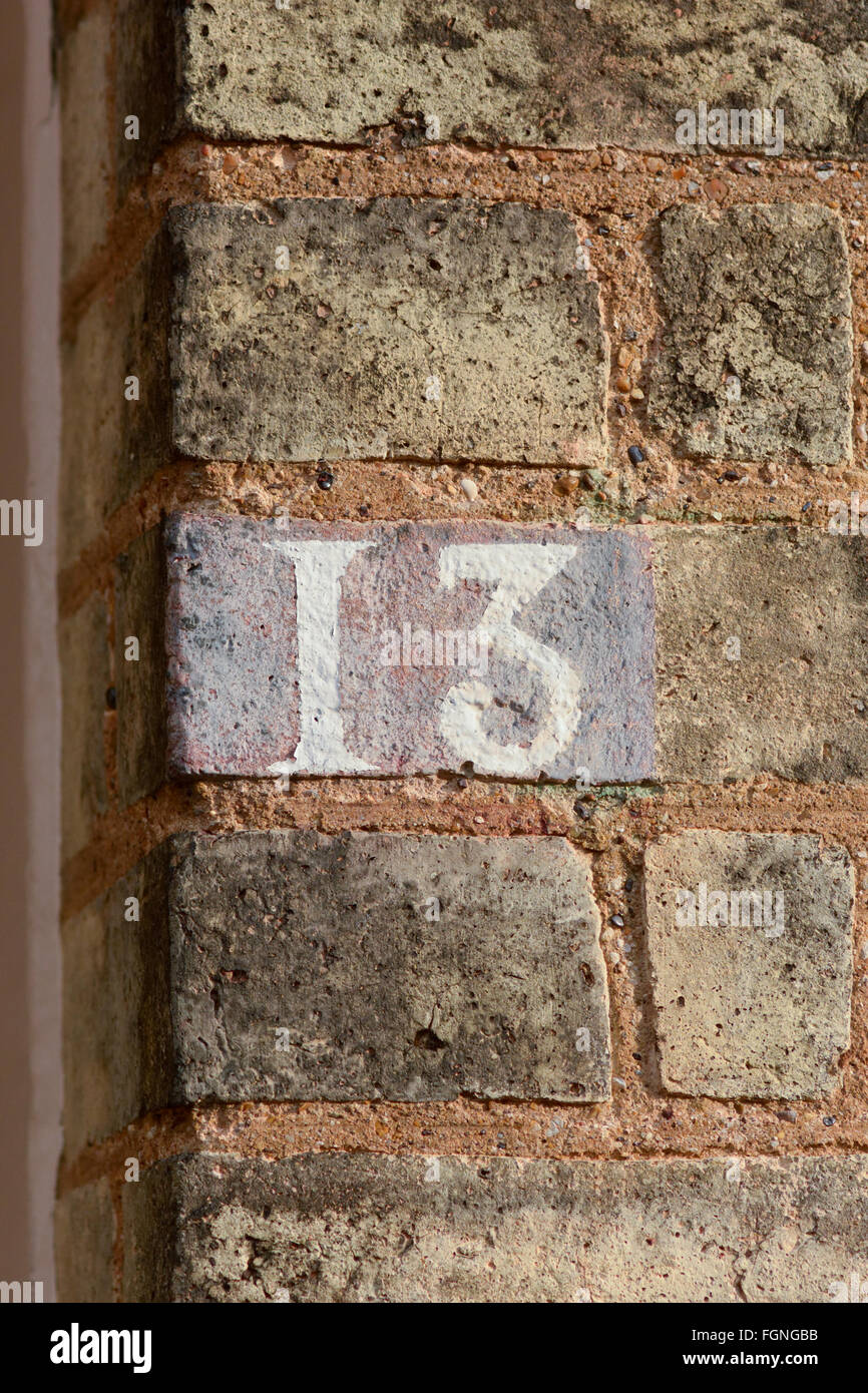 Faded House number 13 painted sign on wall Stock Photo - Alamy