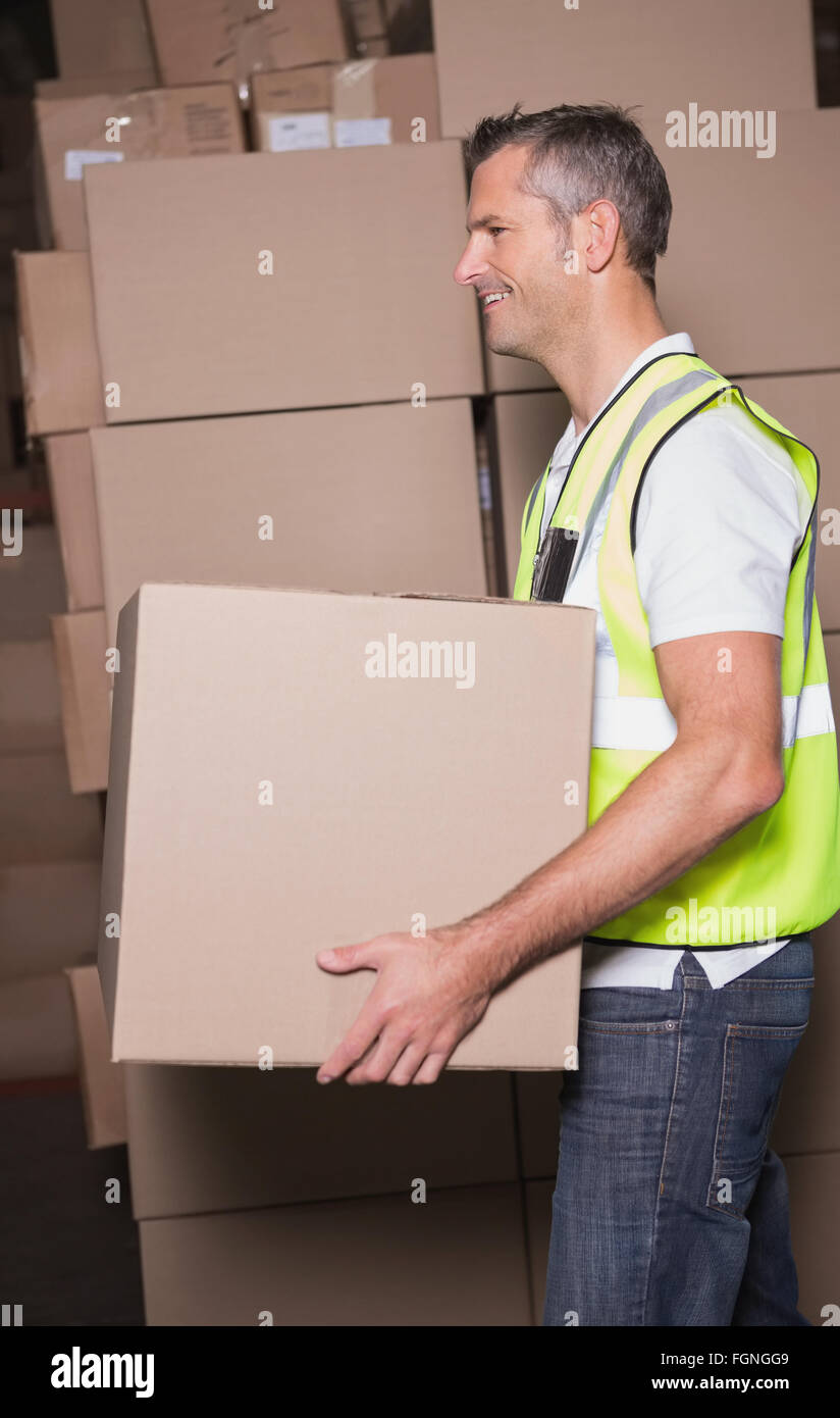 Worker with boxes in warehouse Stock Photo - Alamy