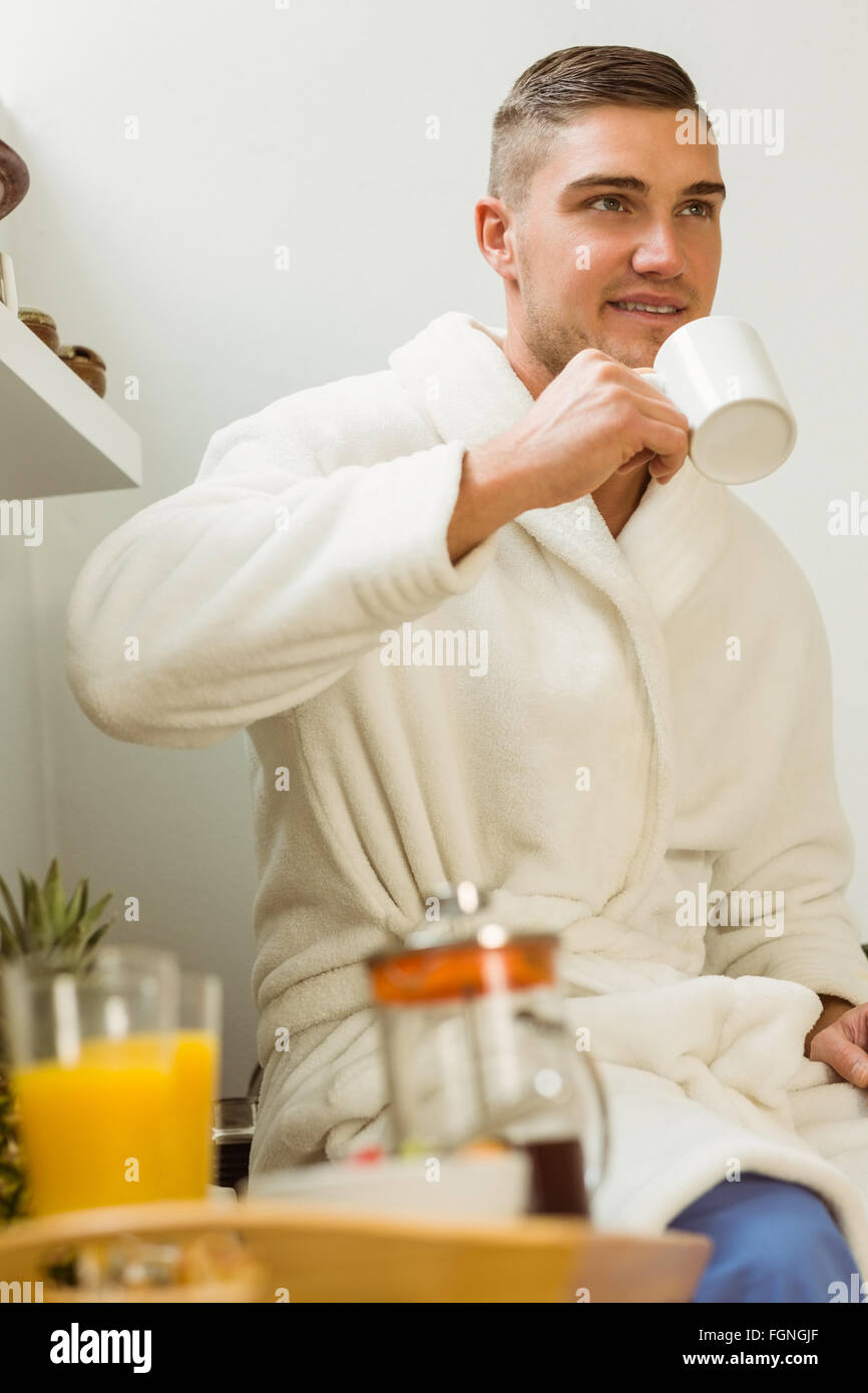 Man drinking coffee in his bathrobe Stock Photo - Alamy