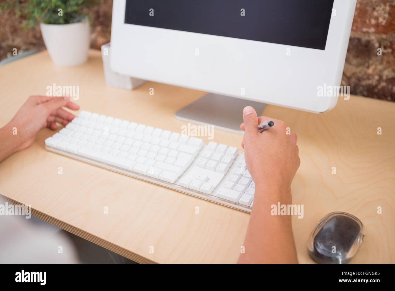Hands using keyboard at desk Stock Photo - Alamy