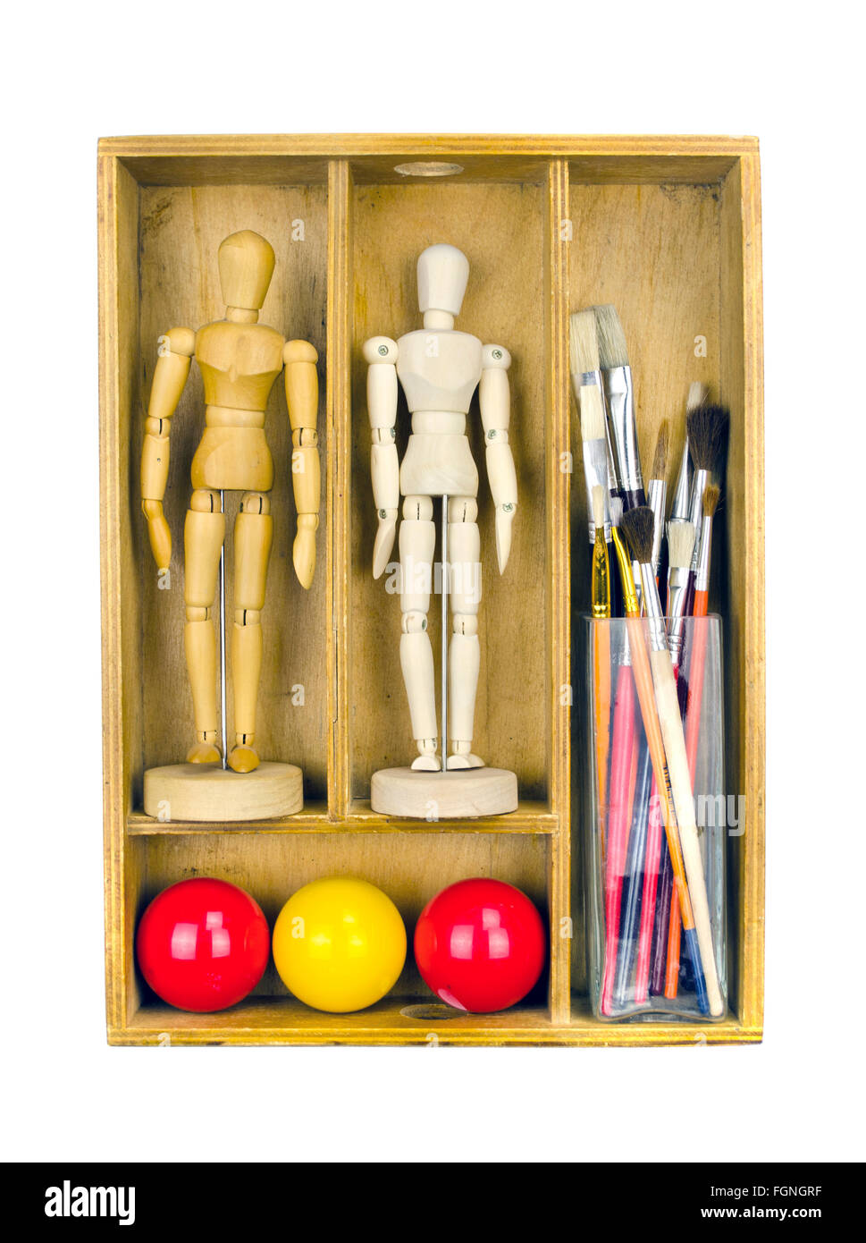 Partitioned wooden shelf filled with objects for drawing and painting ...