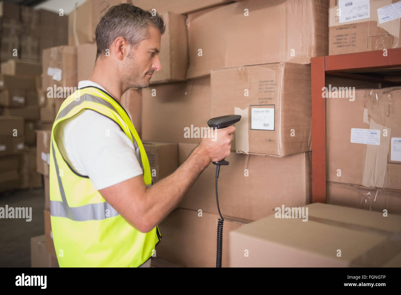 Worker scanning package in warehouse Stock Photo - Alamy