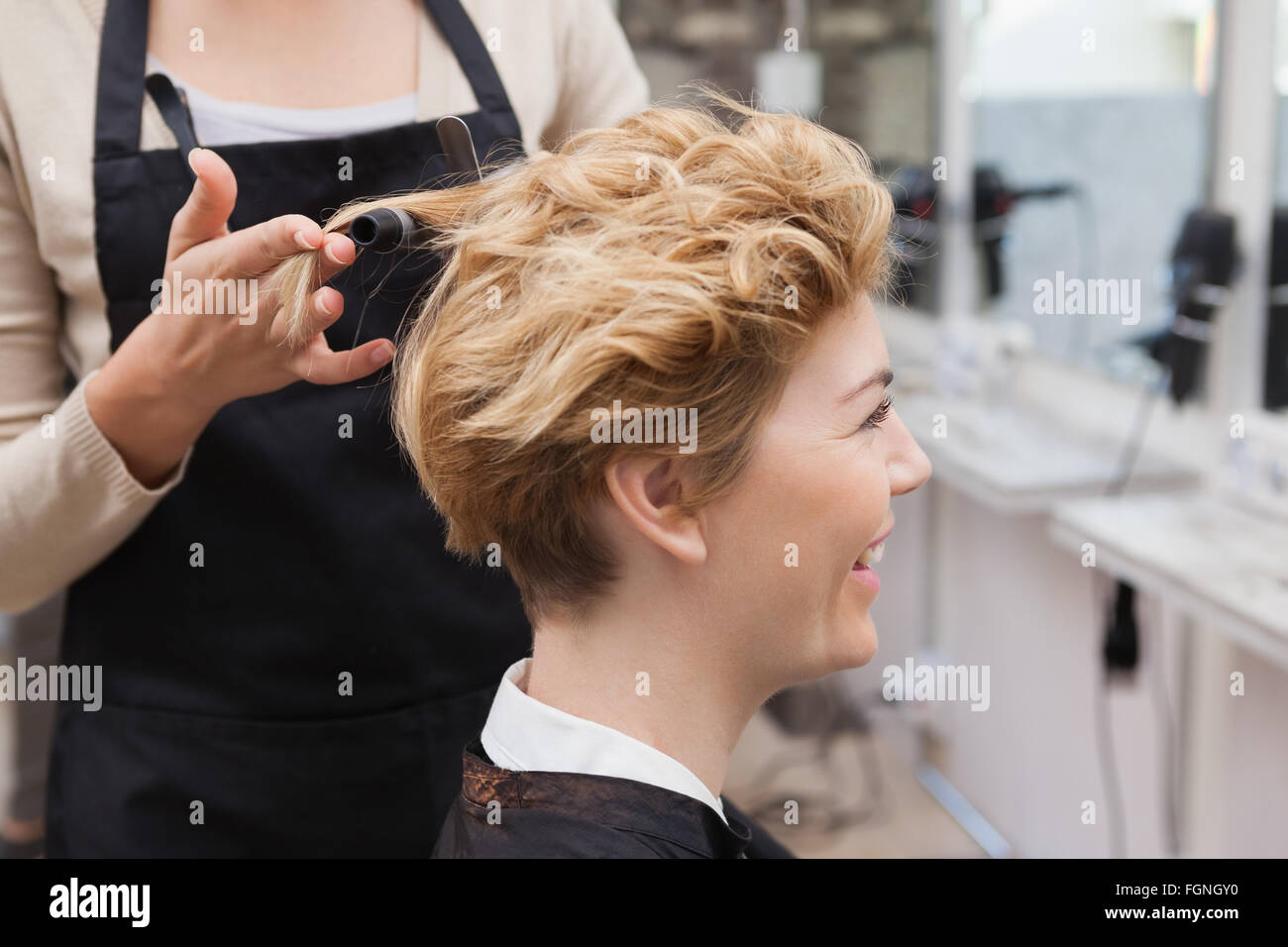 Customer getting her hair styled Stock Photo - Alamy
