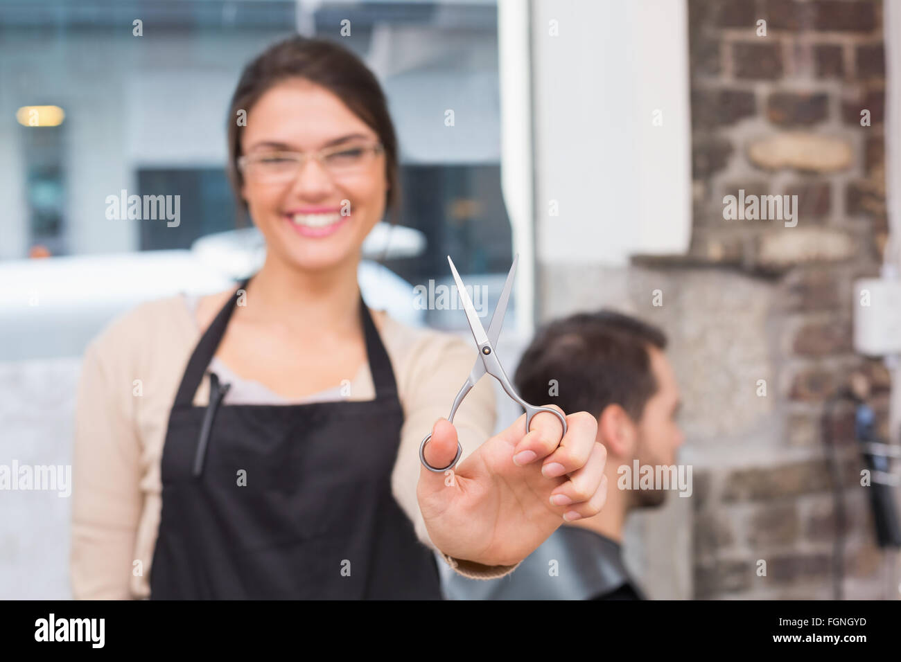 Pretty hair stylist smiling at camera Stock Photo - Alamy