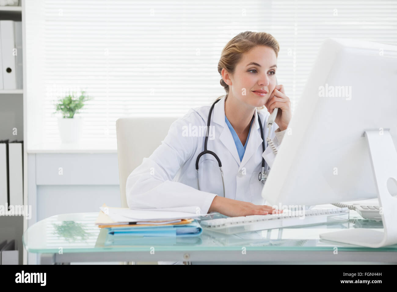 Doctor answering a telephone call Stock Photo - Alamy
