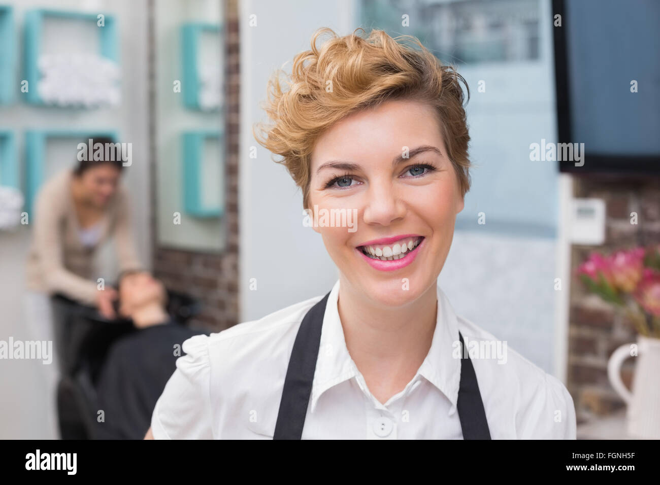 Confident hairdresser smiling at camera Stock Photo - Alamy