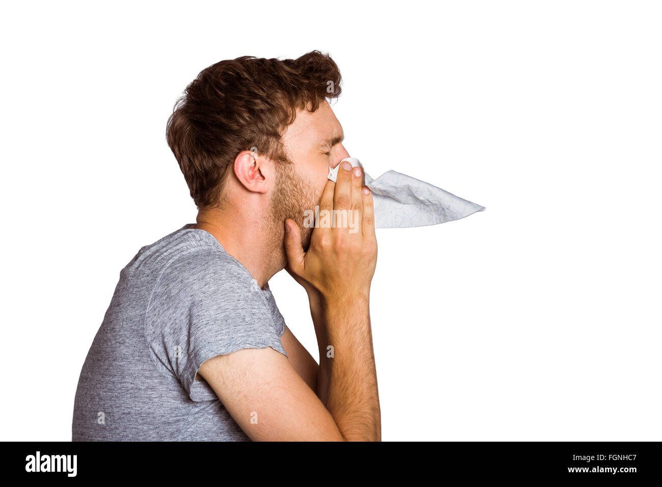 Close up side view of man blowing nose Stock Photo - Alamy