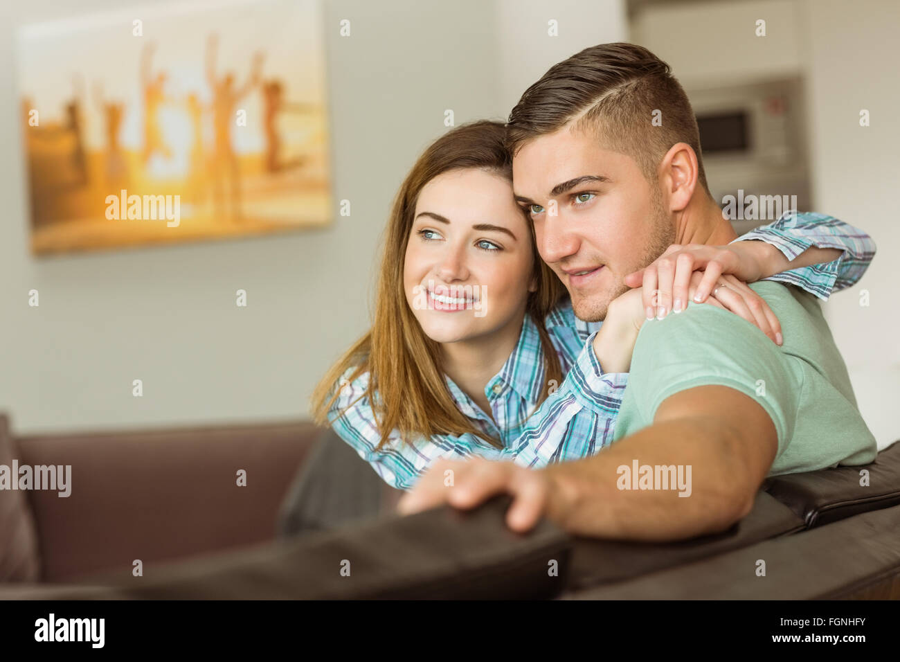 Cute couple relaxing on couch Stock Photo - Alamy