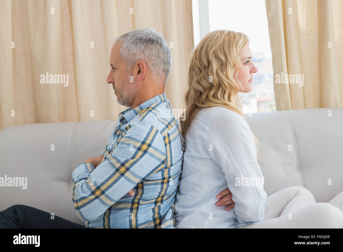 Annoyed couple sitting back hi-res stock photography and images - Alamy