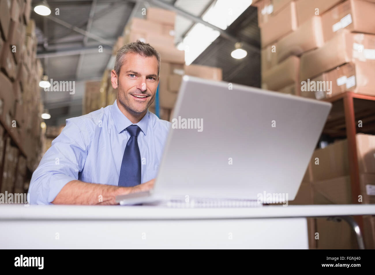 Portrait of warehouse manager with laptop Stock Photo - Alamy