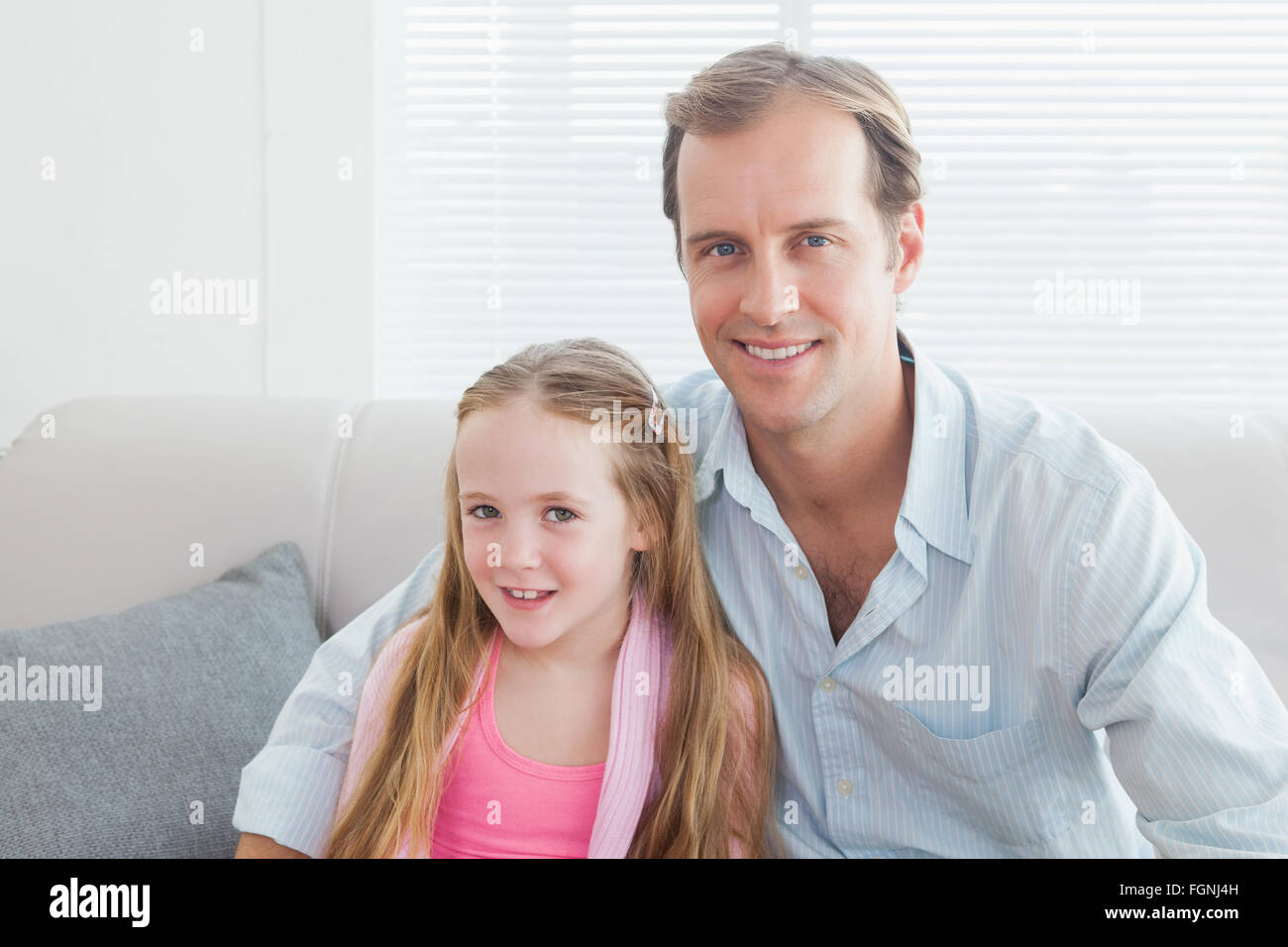 Casual father and daughter smiling at camera Stock Photo - Alamy