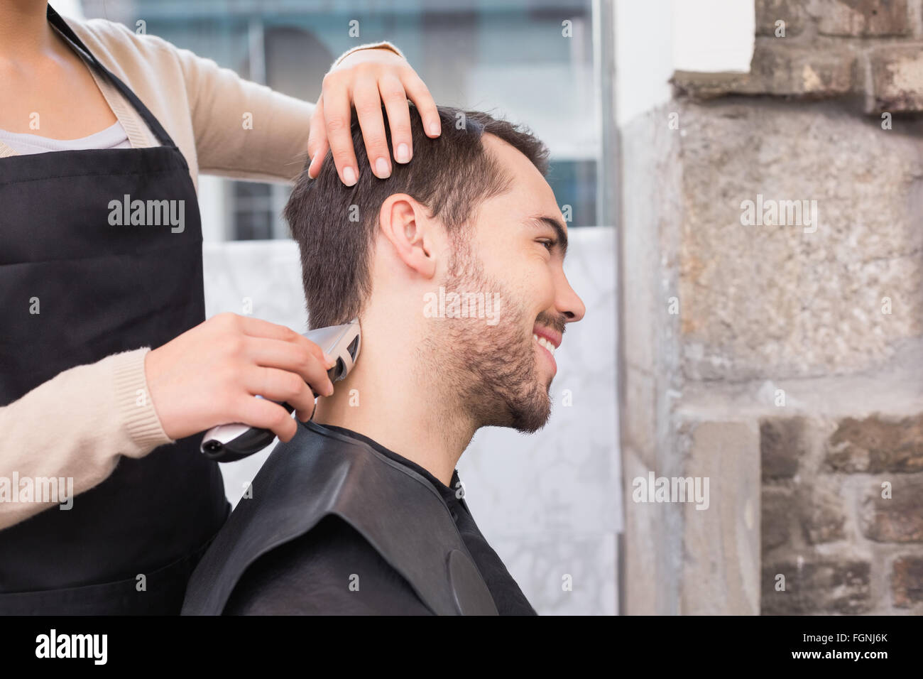 Handsome man getting his hair trimmed Stock Photo - Alamy