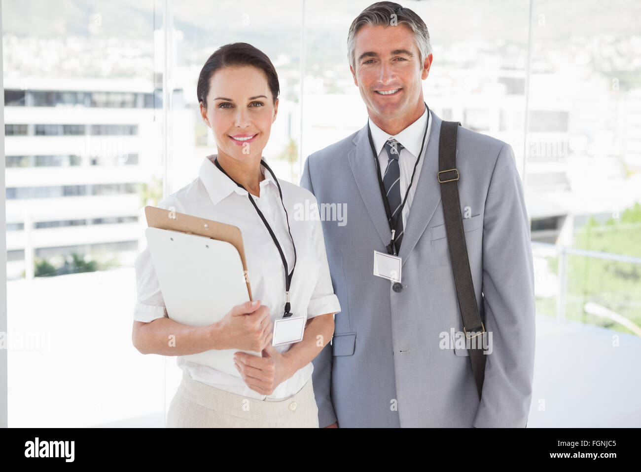 Businessman standing with co worker Stock Photo - Alamy