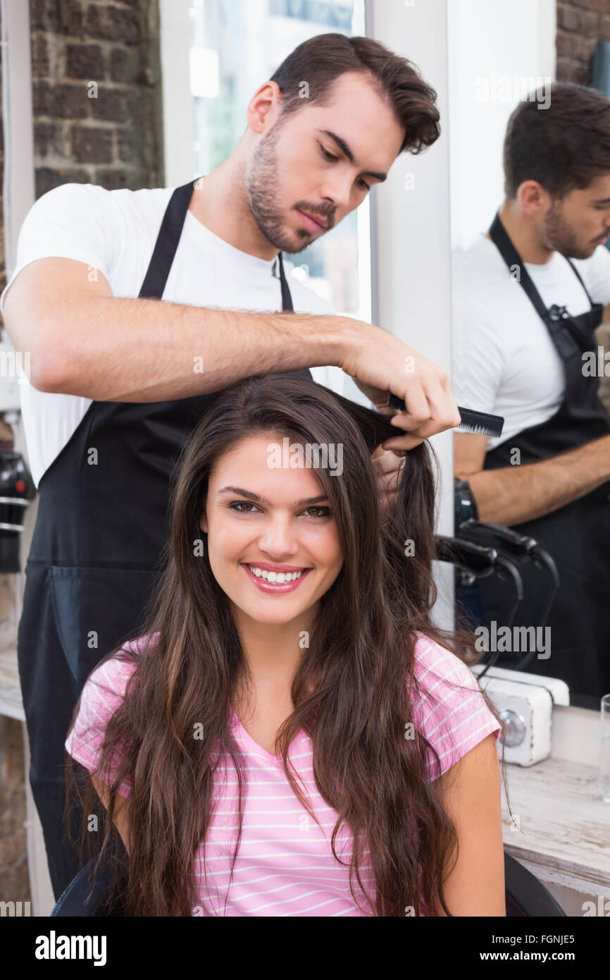 Handsome hair stylist with client Stock Photo - Alamy