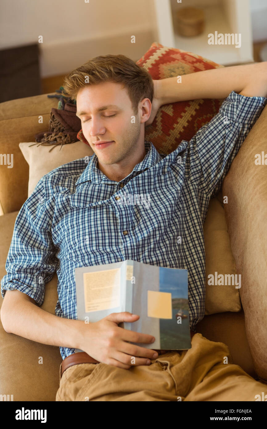 Young man napping on his couch Stock Photo - Alamy