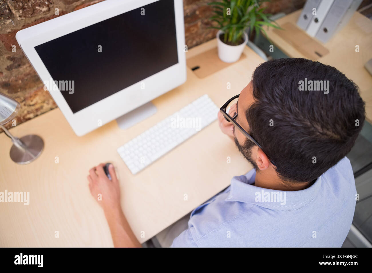 Businessman using computer at desk Stock Photo - Alamy