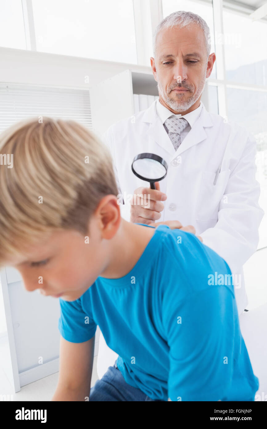 Doctor examining patient with magnifying glass Stock Photo - Alamy