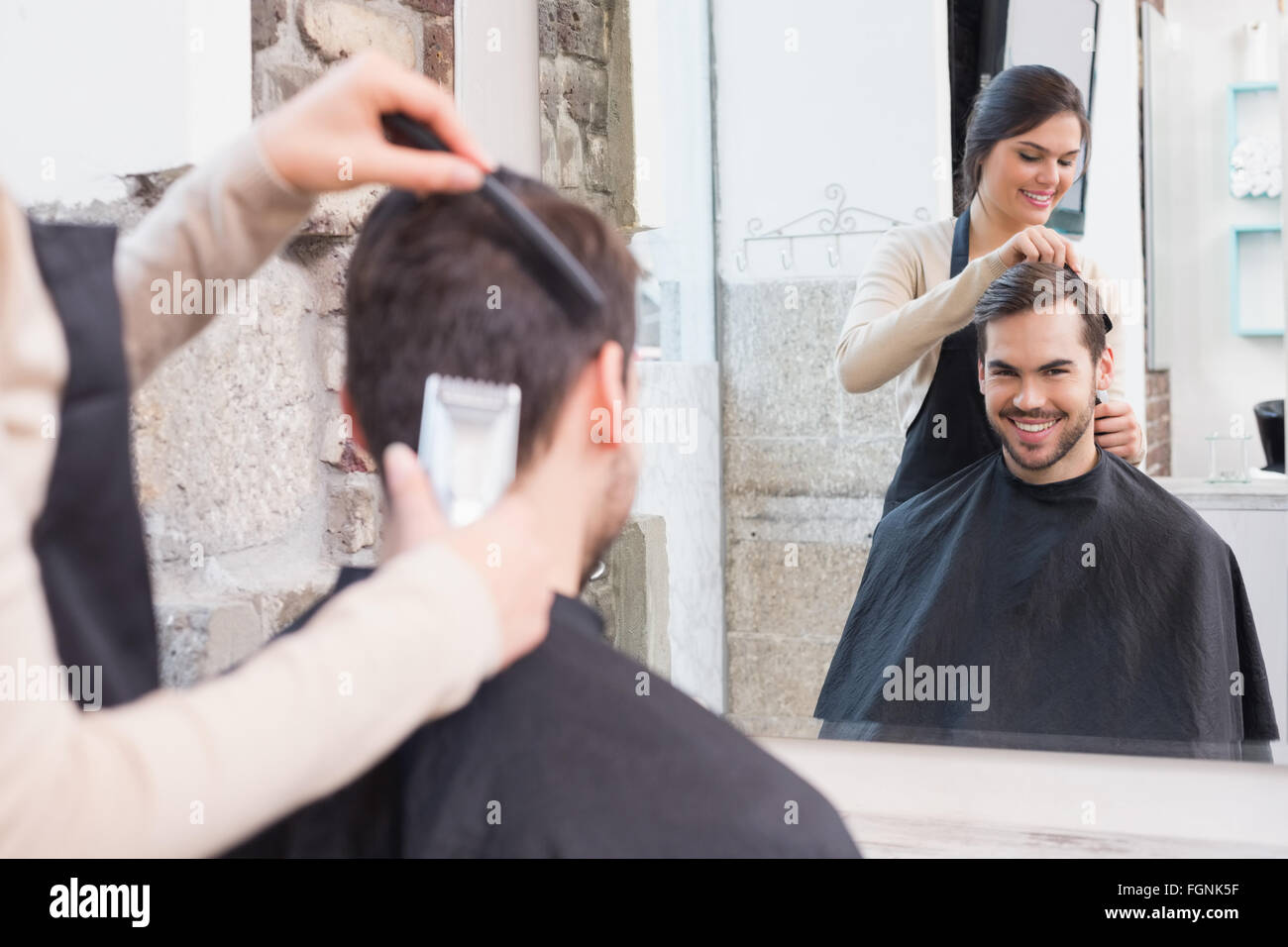 Handsome man getting his hair trimmed Stock Photo - Alamy