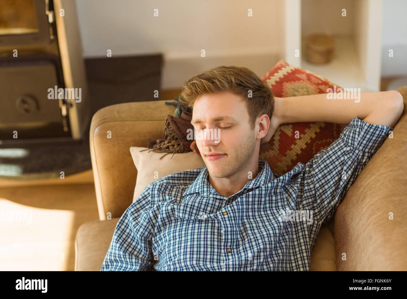 Young man napping on his couch Stock Photo - Alamy