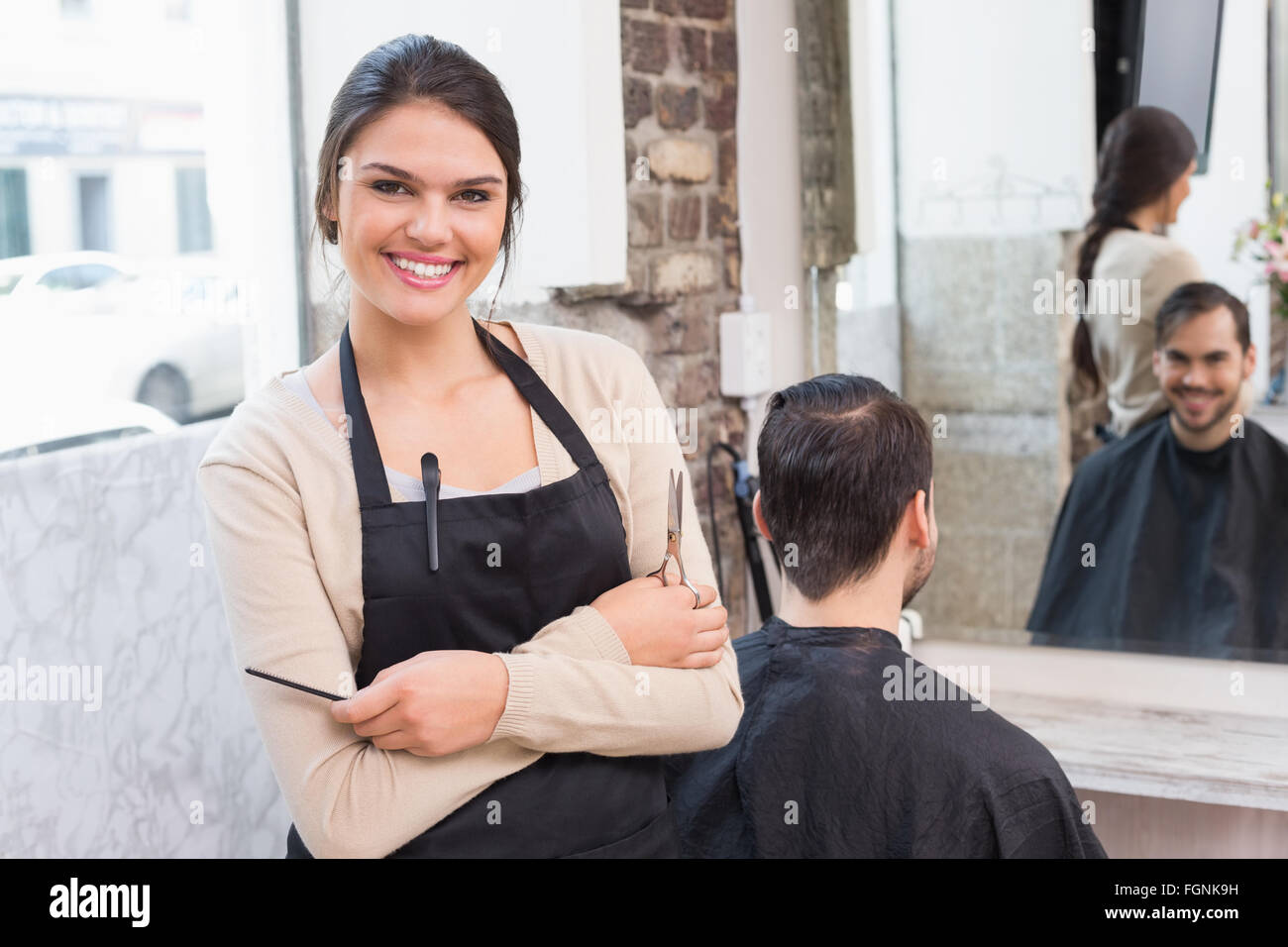 Pretty hair stylist smiling at camera Stock Photo - Alamy