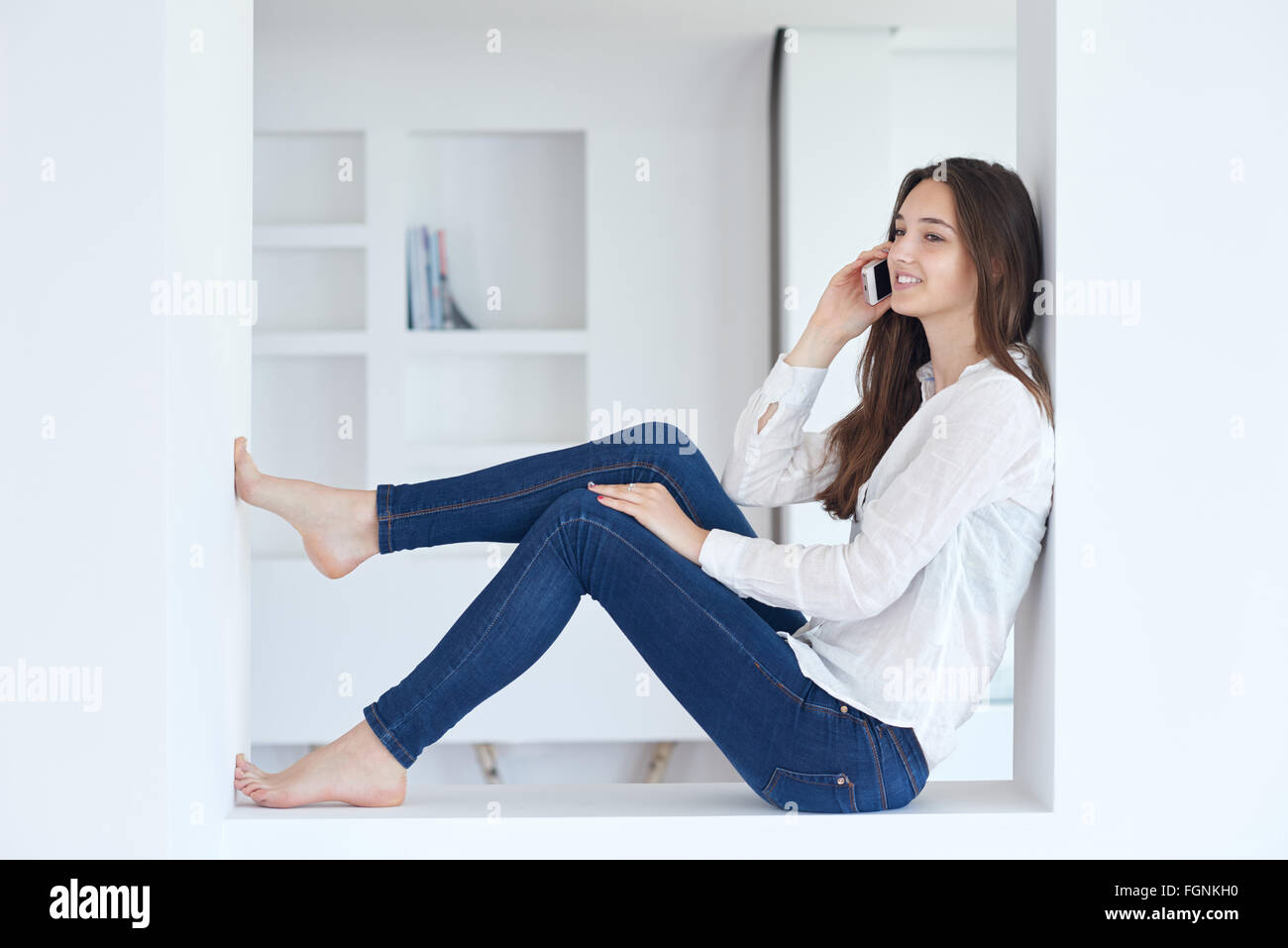 young woman using cellphone at home Stock Photo - Alamy