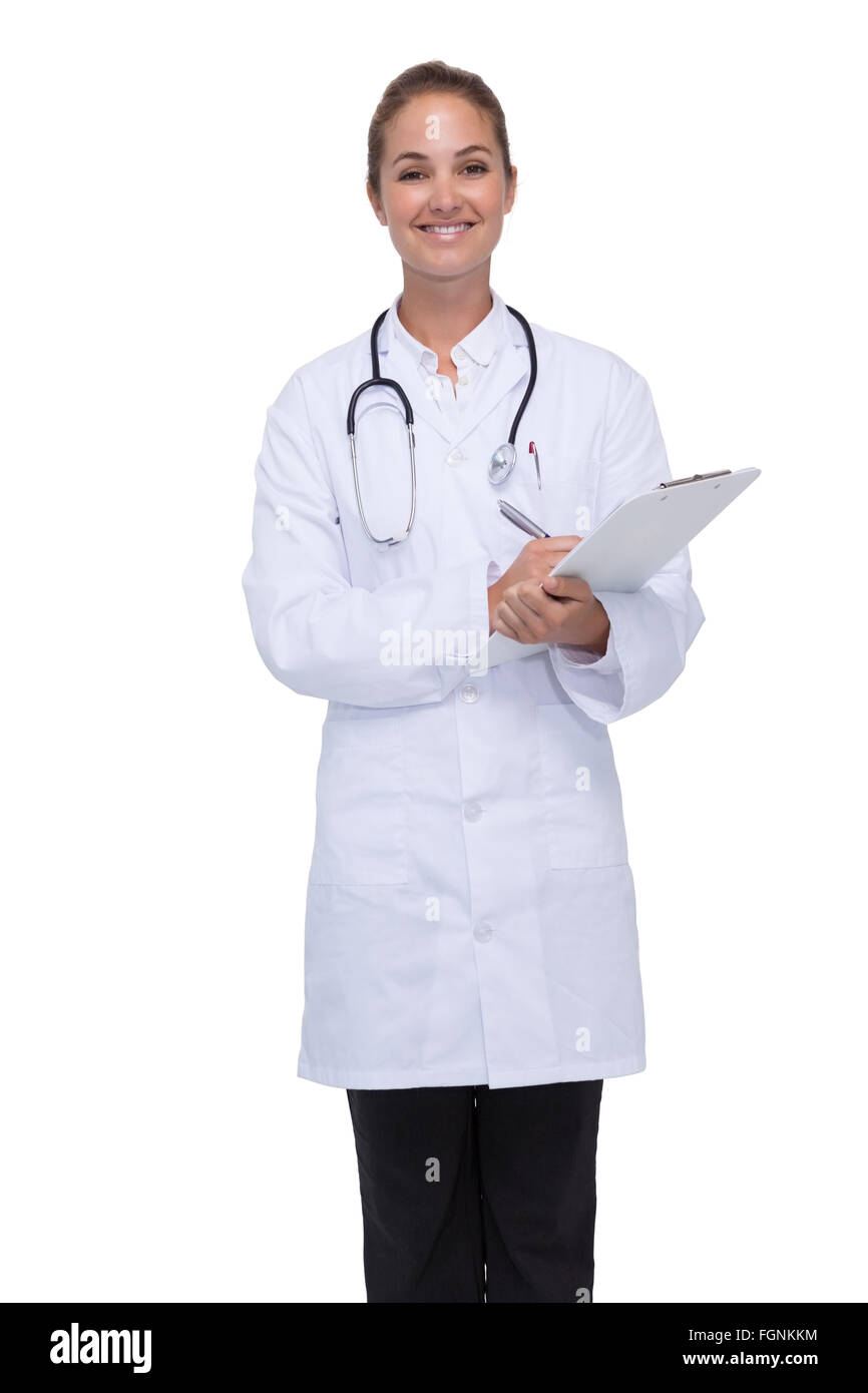 Smiling doctor taking down notes Stock Photo - Alamy