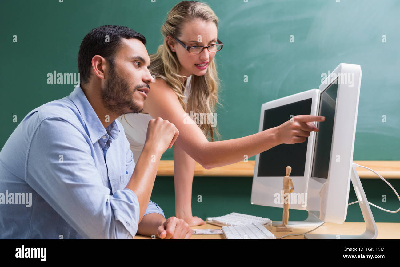 Casual colleagues using computer at office Stock Photo - Alamy