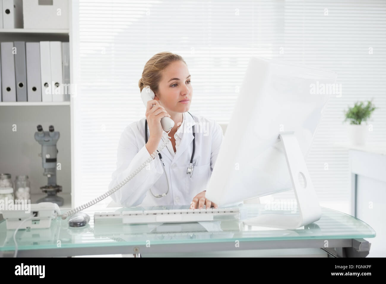 Doctor taking a phone call Stock Photo - Alamy