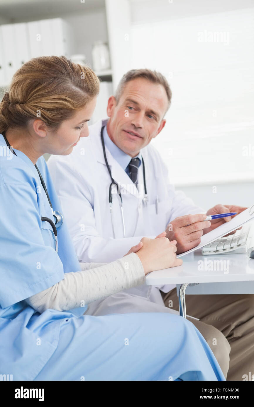Doctor and nurse looking at a computer Stock Photo - Alamy