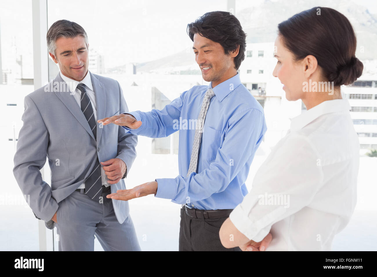 Happy employees having a discussion Stock Photo - Alamy