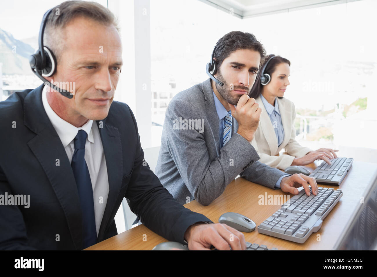 Focused business team working hard Stock Photo - Alamy