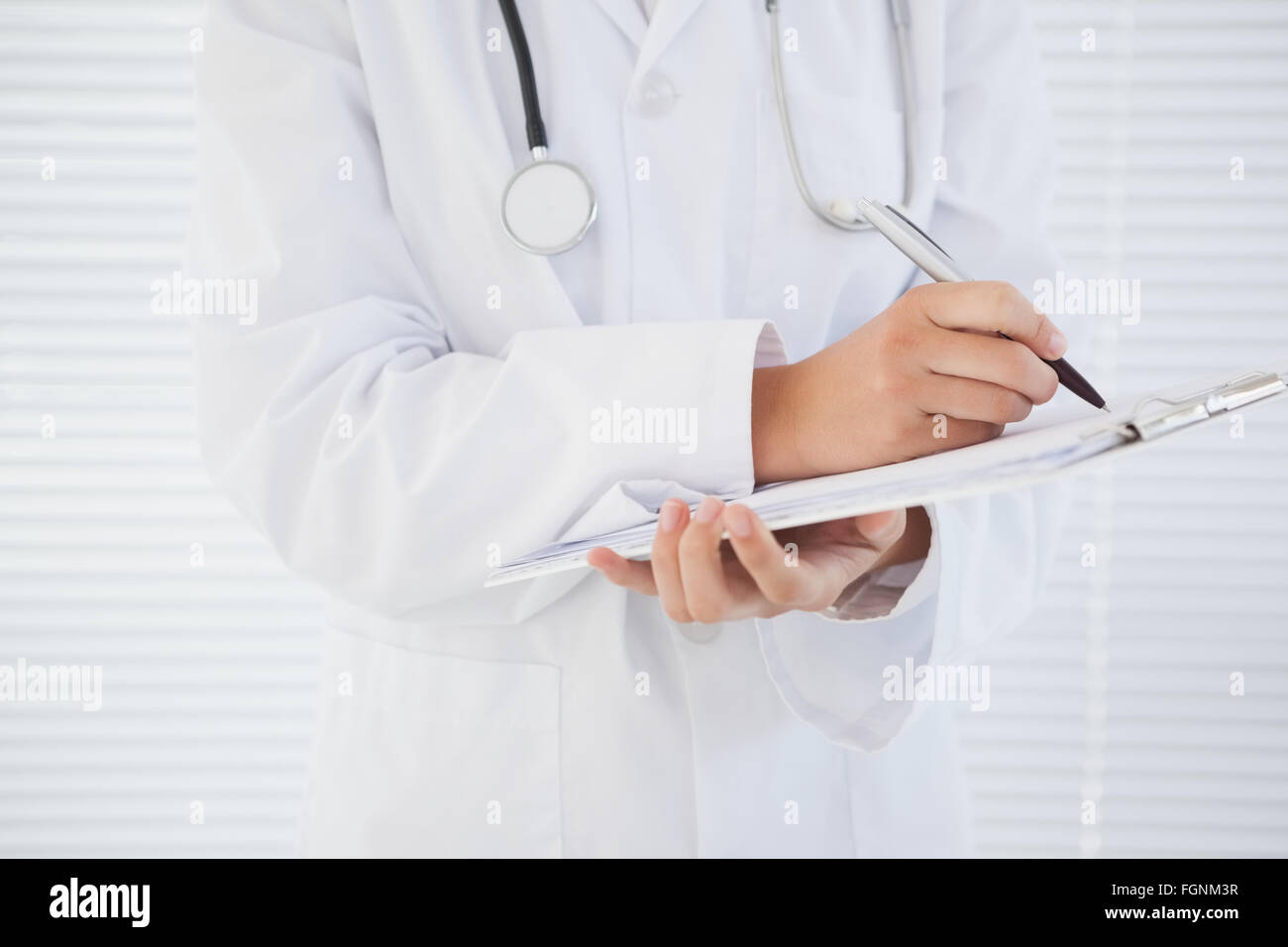Doctor writing down some notes Stock Photo - Alamy