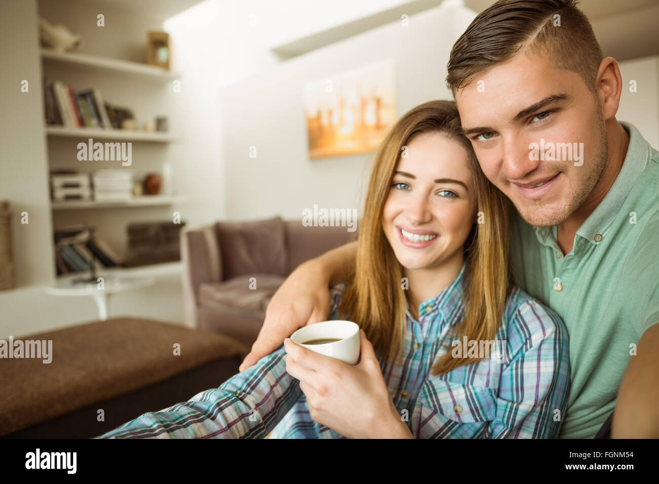 Cute couple relaxing on couch Stock Photo - Alamy