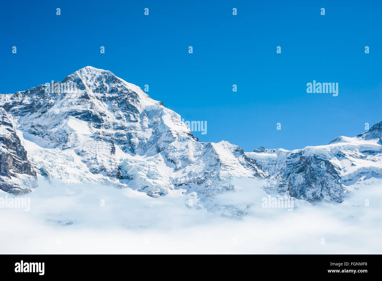 Snow mountain with cloud or fog and blue sky Stock Photo - Alamy