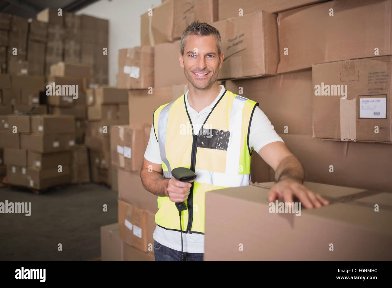 Worker scanning package in warehouse Stock Photo - Alamy