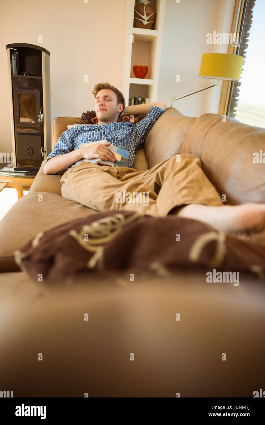 Young man napping on his couch Stock Photo - Alamy