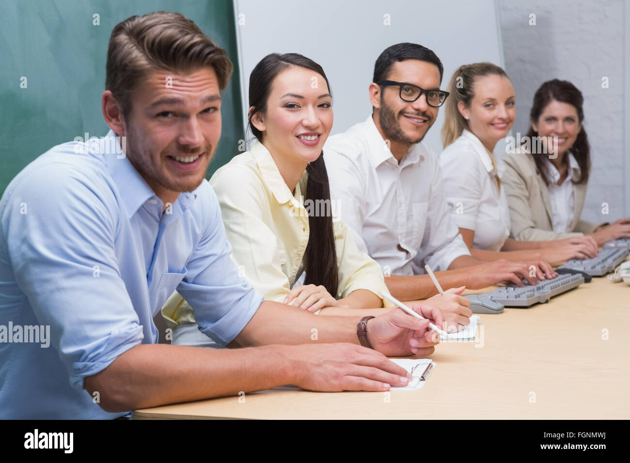 Five person Business team looking at camera and smiling Stock Photo - Alamy