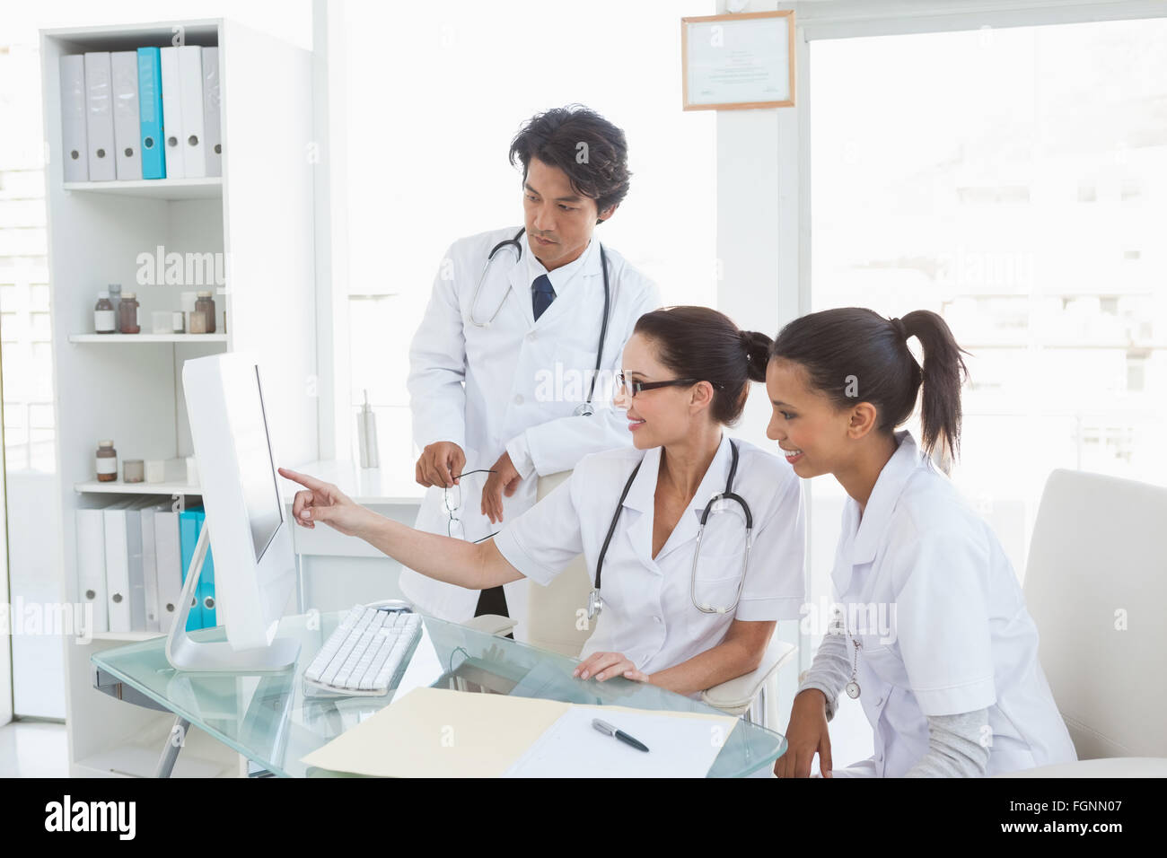 Hard working doctors reviewing notes Stock Photo - Alamy