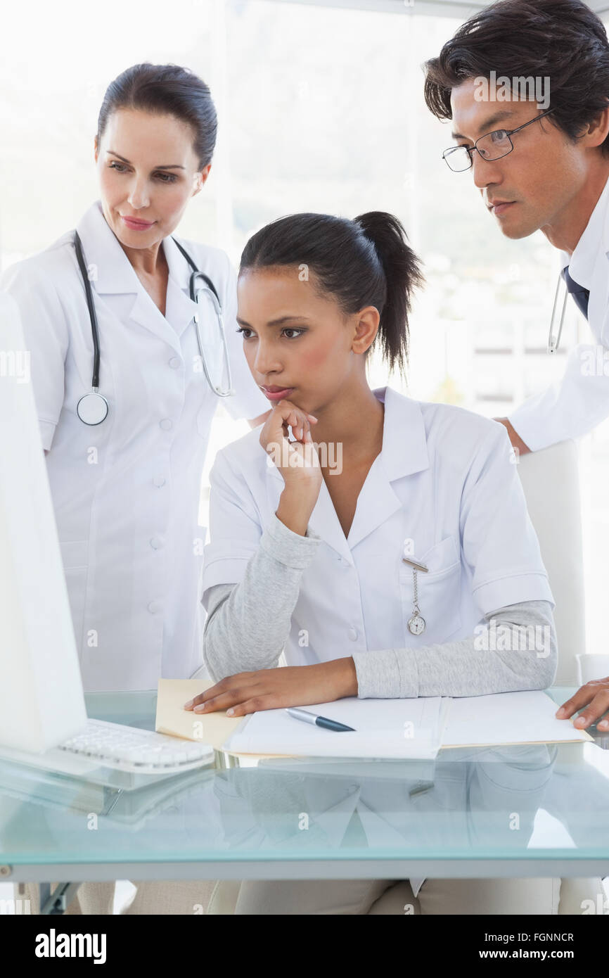 Doctors looking at a computer monitor Stock Photo - Alamy